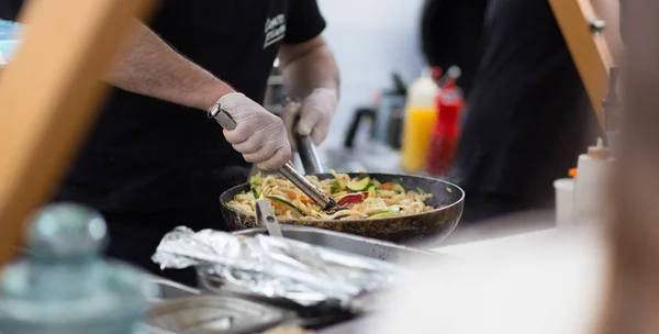 Cheff cooking on outdoor street food festival. - Stock Image - Everypixel