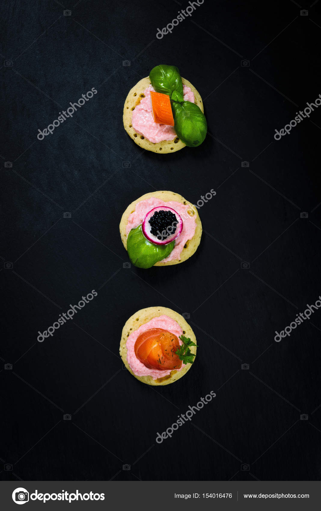 Homemade pancake canapes on slate stone plate for finger food party ...