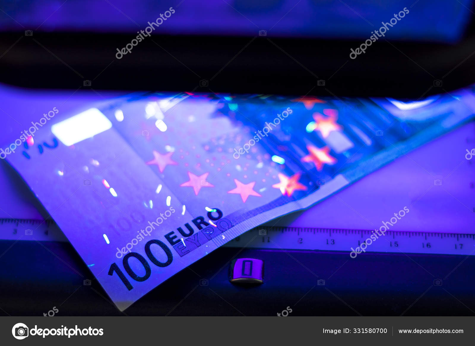 100 Euro banknote. Lying in the ultraviolet to verify the authenticity ...