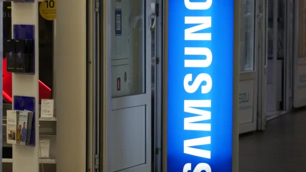 Glowing blue SAMSUNG signboard in shopping center. Stock Video Footage ...