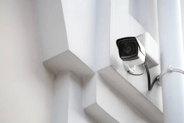Modern CCTV camera installed on wall of building outdoors — Stock Photo ...