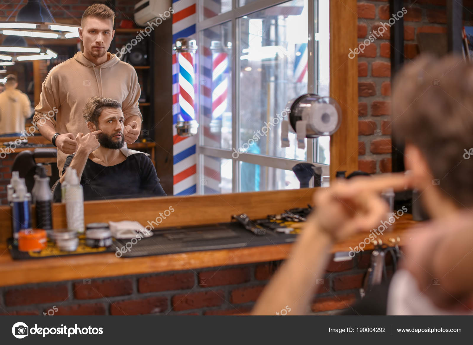 Professional barber working with client in hairdressing salon Stock ...