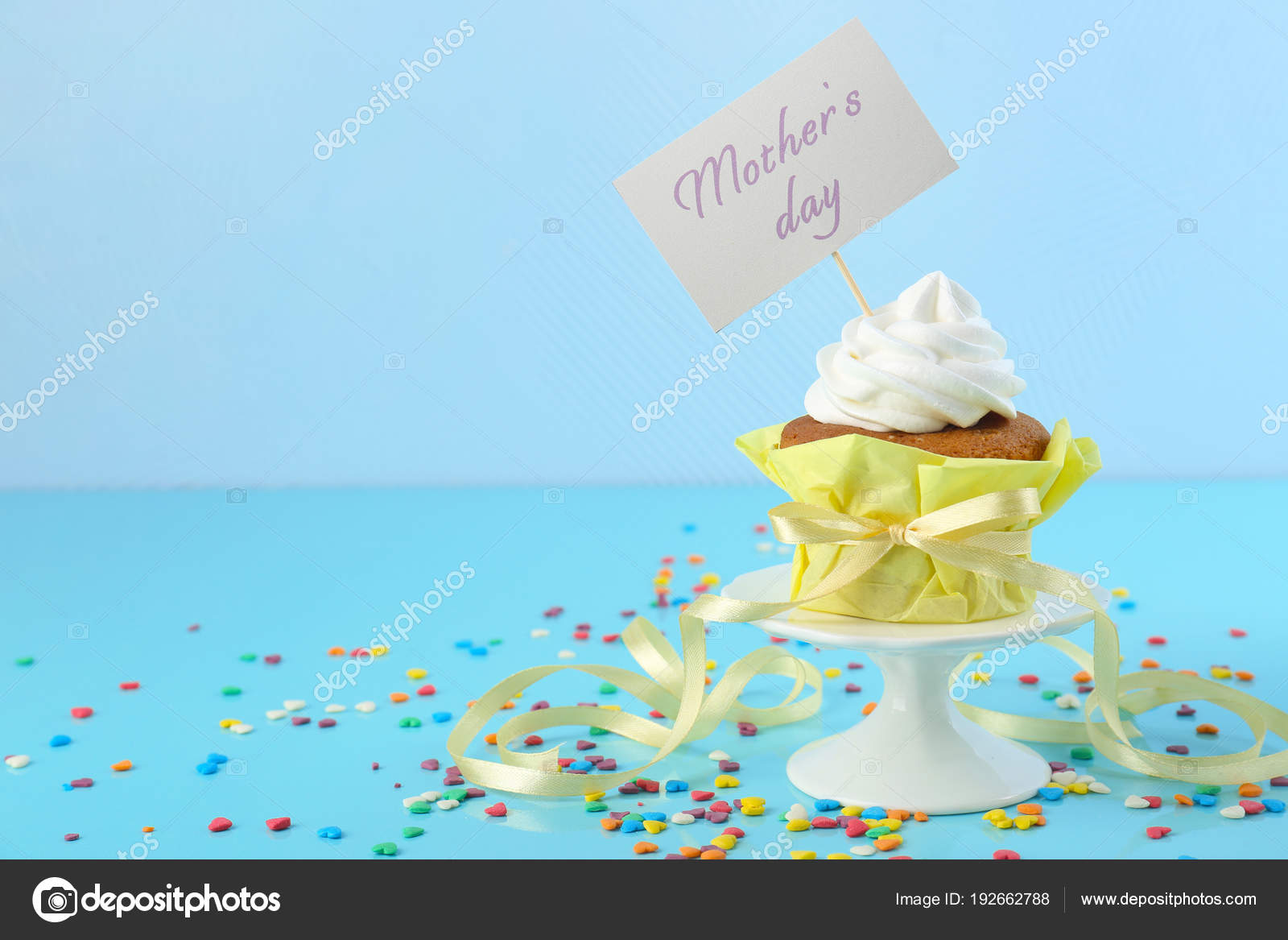 Tasty cupcake and card with words MOTHER'S DAY on color background ...