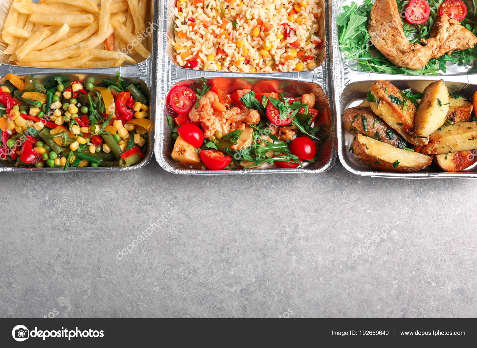 Food delivery containers with different meals on light table, top view ...