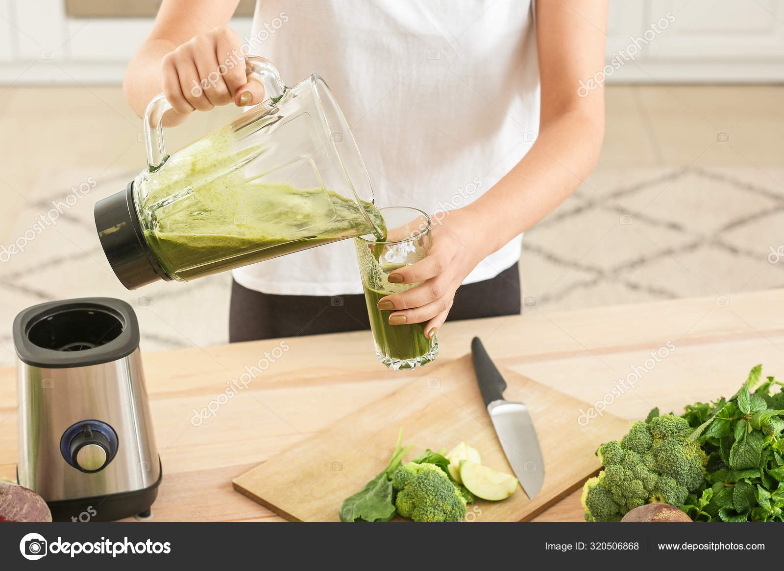 Woman pouring healthy smoothie into glass in kitchen — Stock Photo ...
