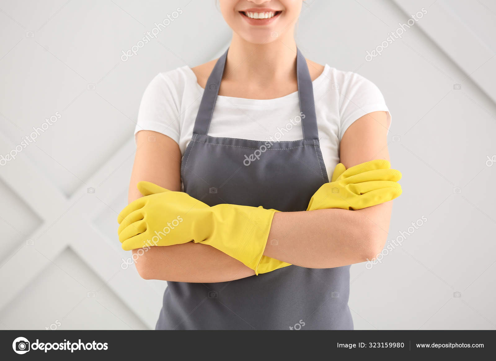 Female janitor on grey background Stock Photo by ©serezniy 323159980