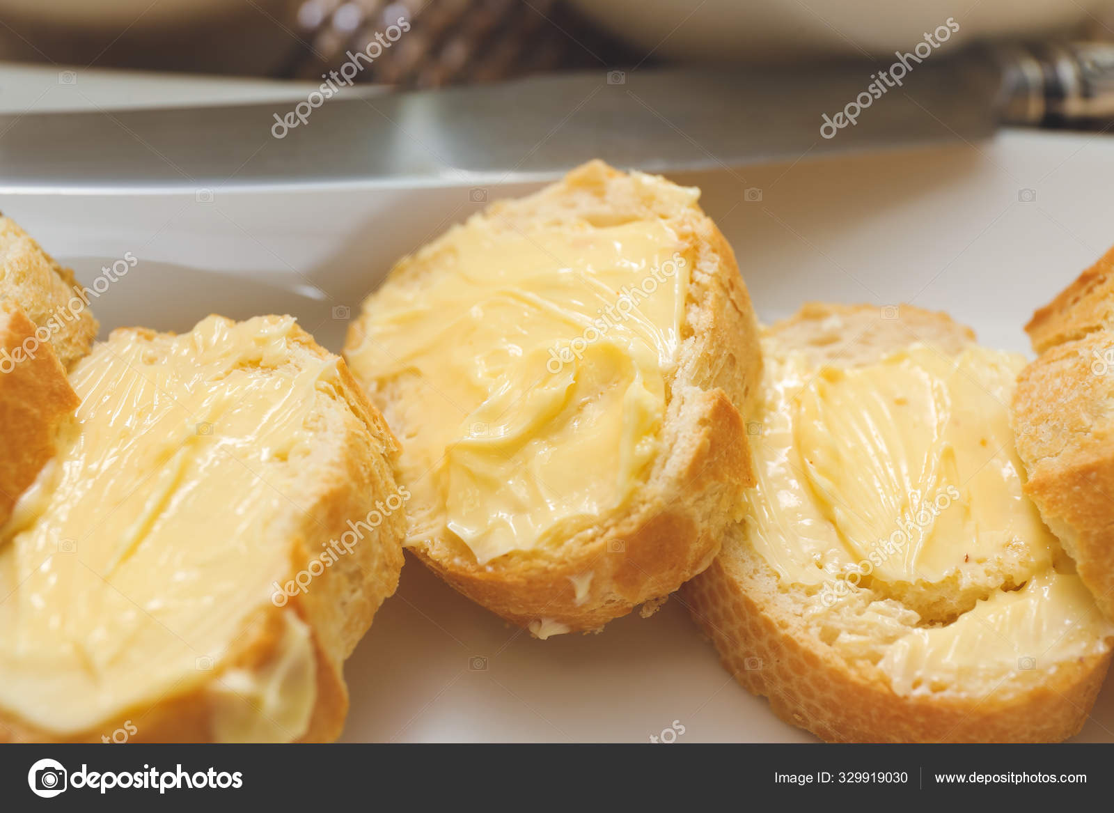 Plate with tasty bread and butter on tray, closeup Stock Photo by ...