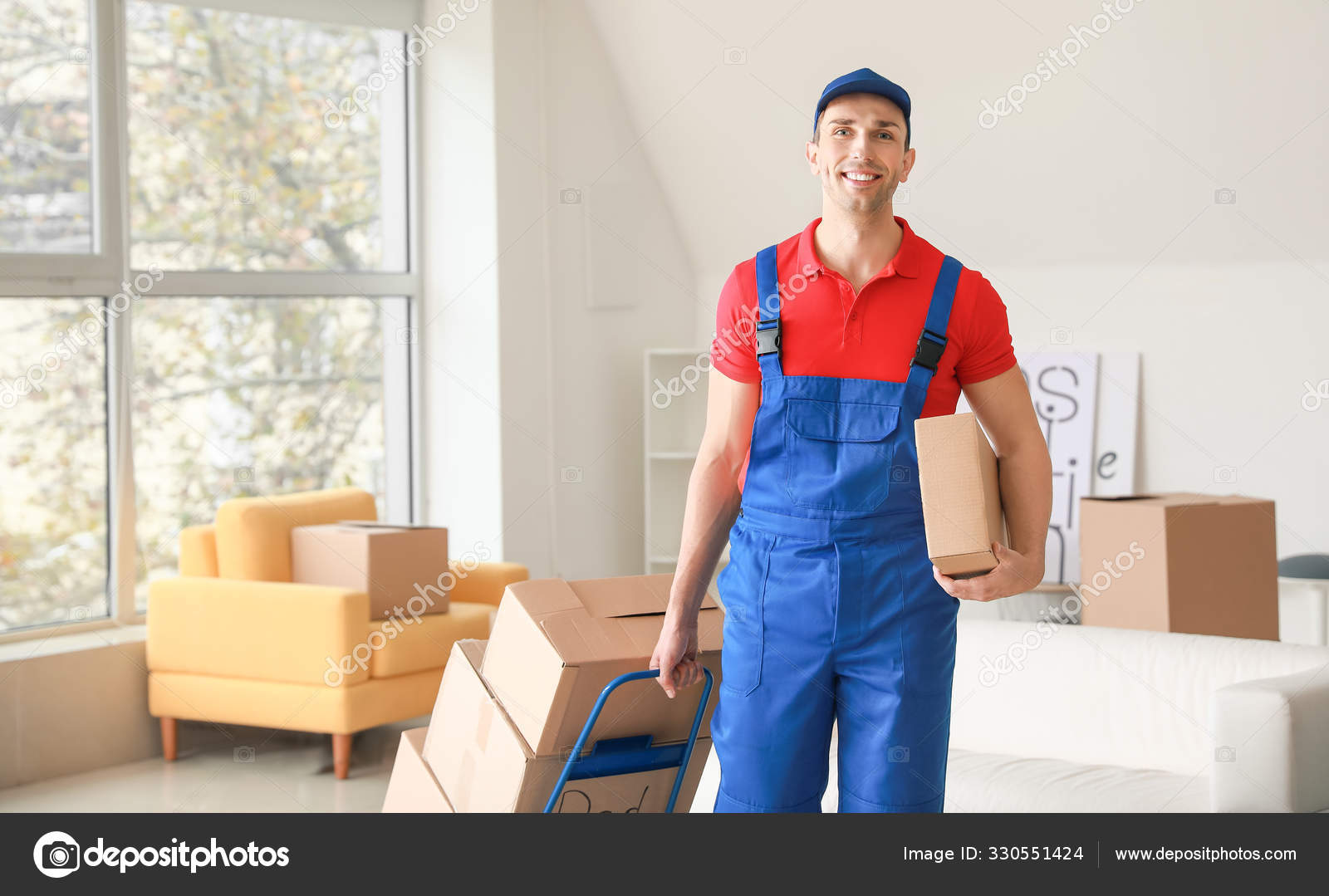 Delivery man with boxes in room — Stock Photo © serezniy #330551424