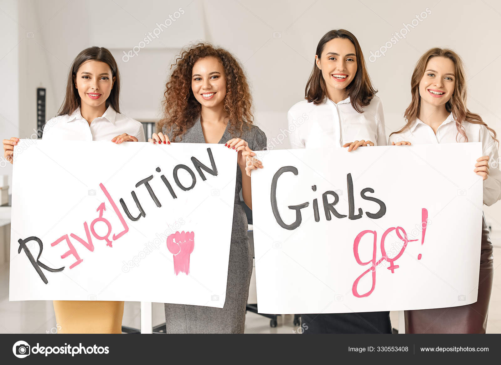 Young women with posters in office. Concept of feminism Stock Photo by ...