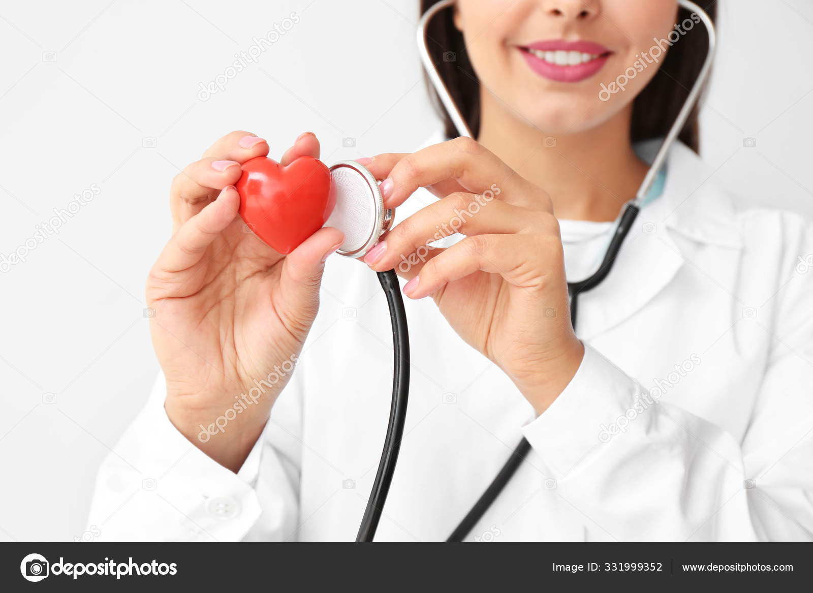 Female cardiologist on light background Stock Photo by ©serezniy 331999352