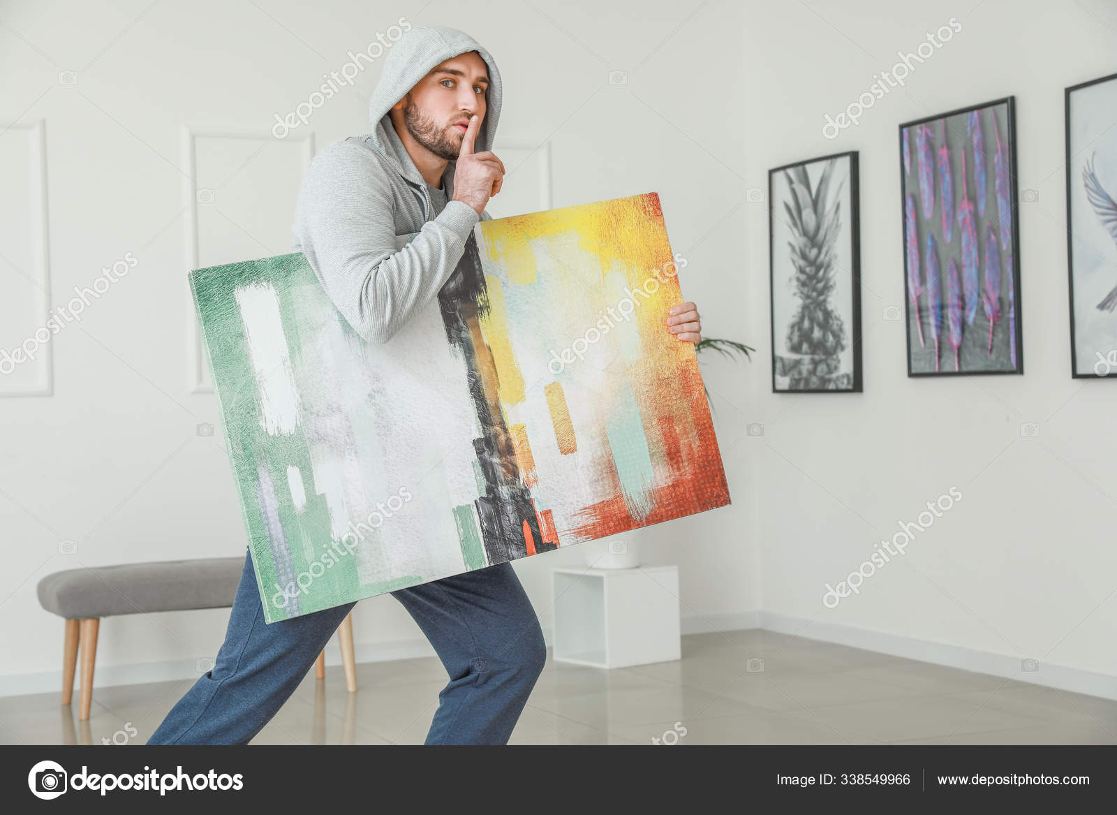 Thief stealing picture from art gallery Stock Photo by ©serezniy 338549966