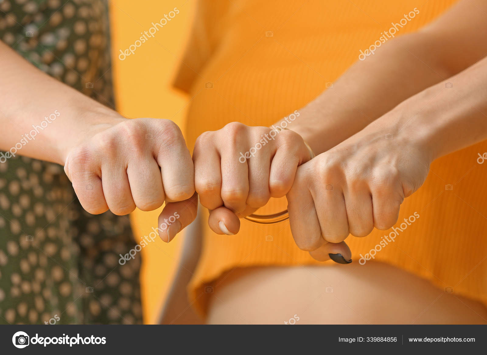 Beautiful young women putting hands together on color background. Unity ...