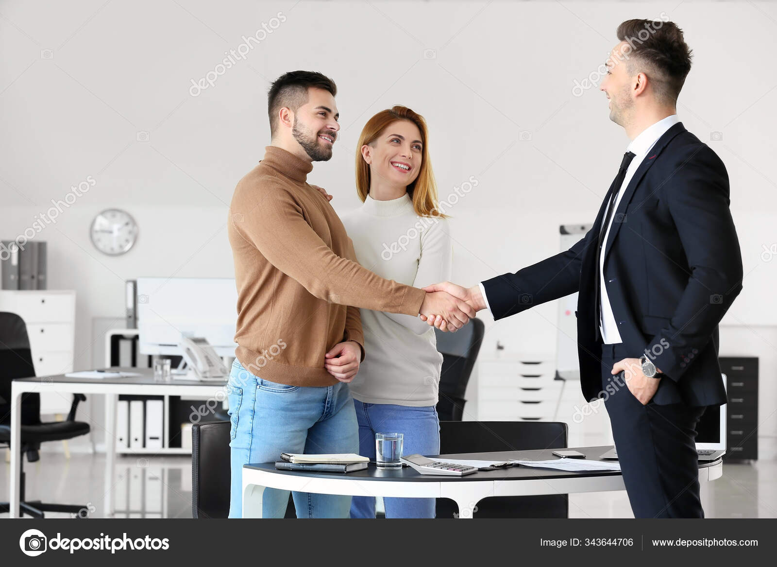 Bank manager and clients shaking hands in office Stock Photo by ...