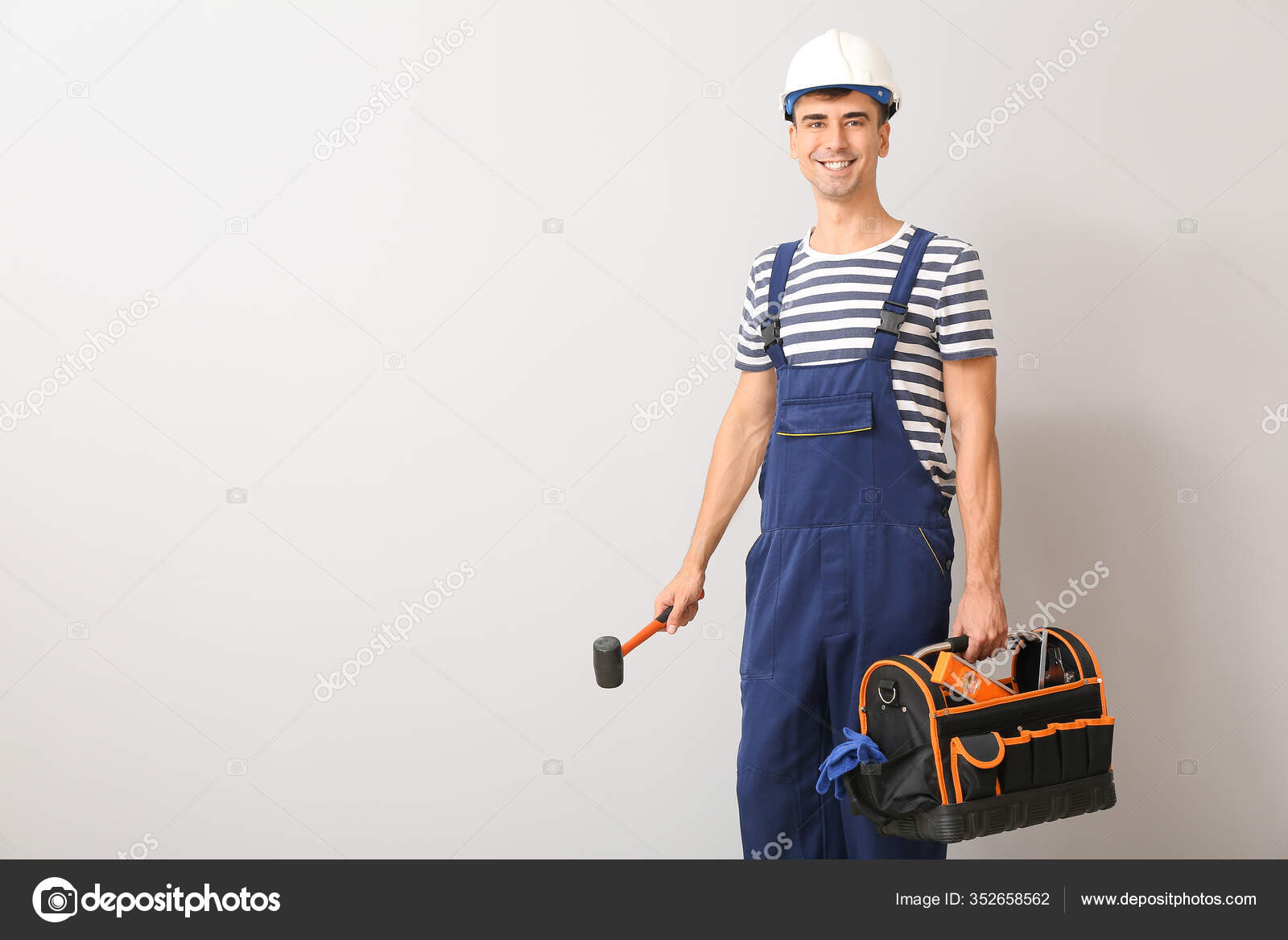 Handsome Male Worker Light Background Stock Photo by ©serezniy 352658562