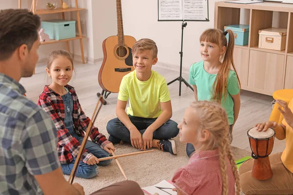 Teacher giving music lessons at school - Stock Image - Everypixel