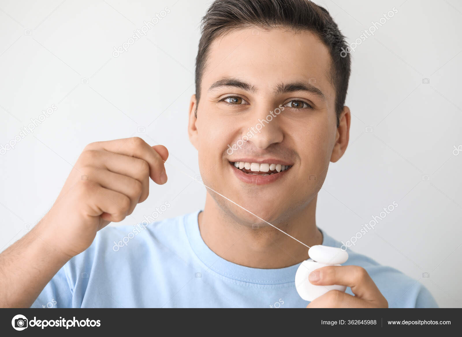 Handsome Man Flossing Teeth Light Background Stock Photo by ©serezniy ...