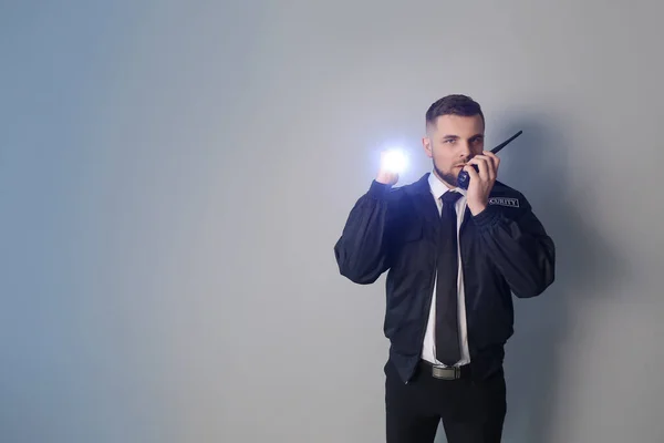 Male Security Guard Flashlight Grey Background Stock Photo by ©serezniy ...