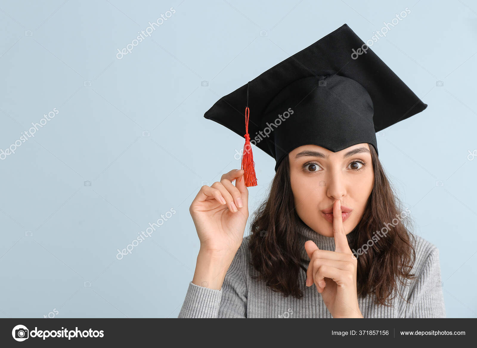 Female Graduating Student Showing Silence Gesture Light Background ...