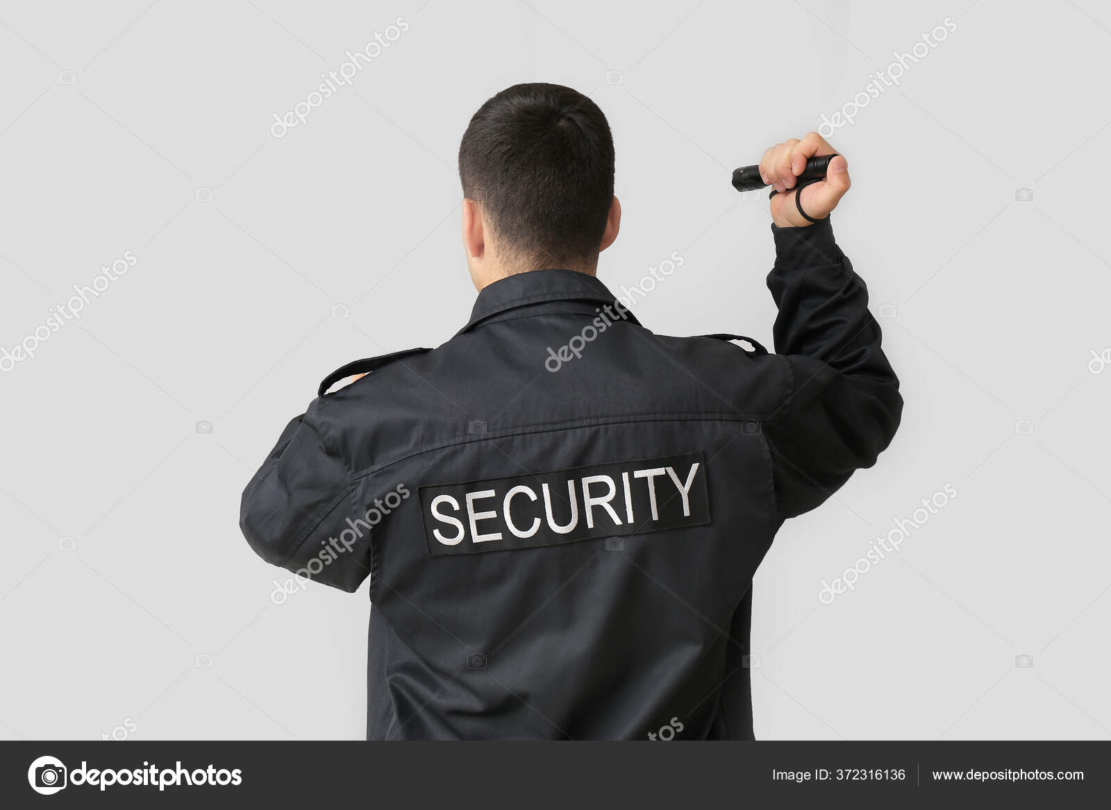 Male Security Guard Flashlight Grey Background Stock Photo by ©serezniy ...