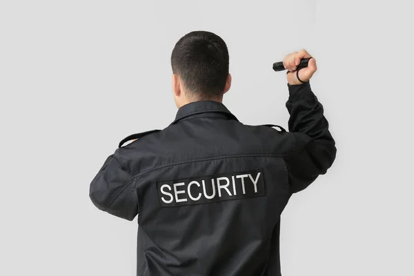 Male Security Guard Flashlight Grey Background Stock Photo by ©serezniy ...