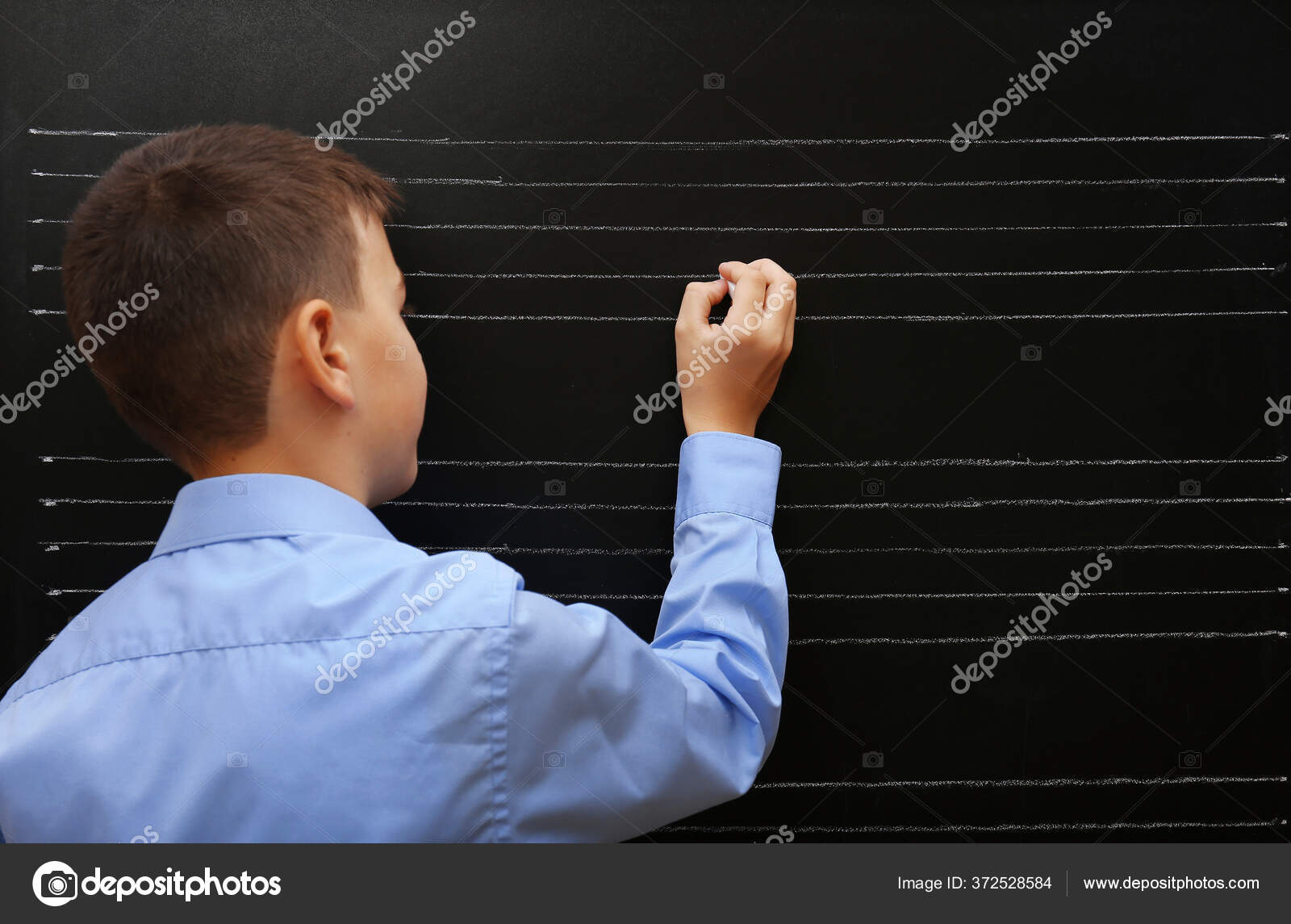 Young Cute Schoolboy Writing Blackboard Stock Photo by ©serezniy 372528584