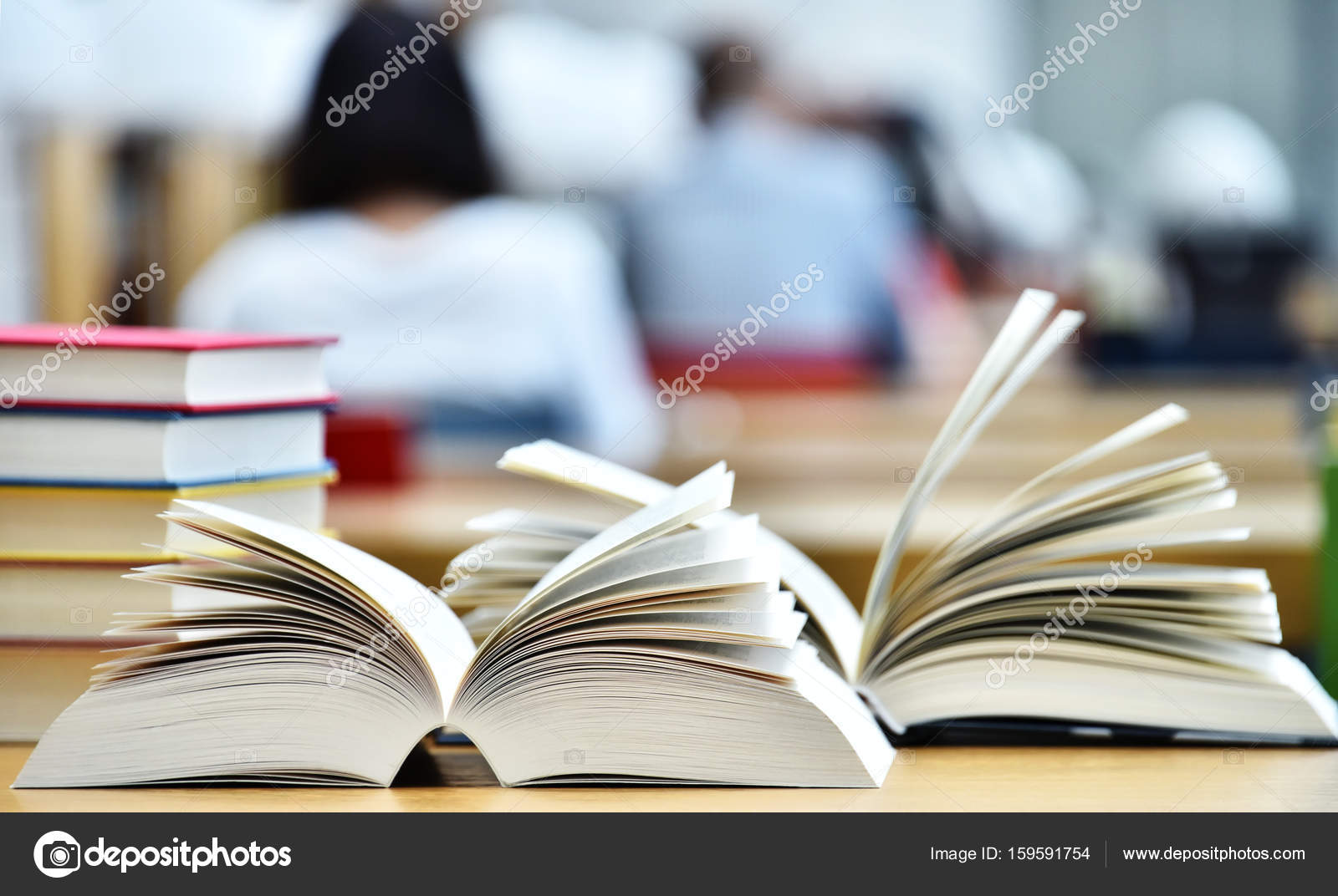 Books lying on the table in the public library Stock Photo by ...