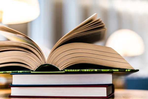 Open book lying on the table in the library — Stock Photo © monticello ...