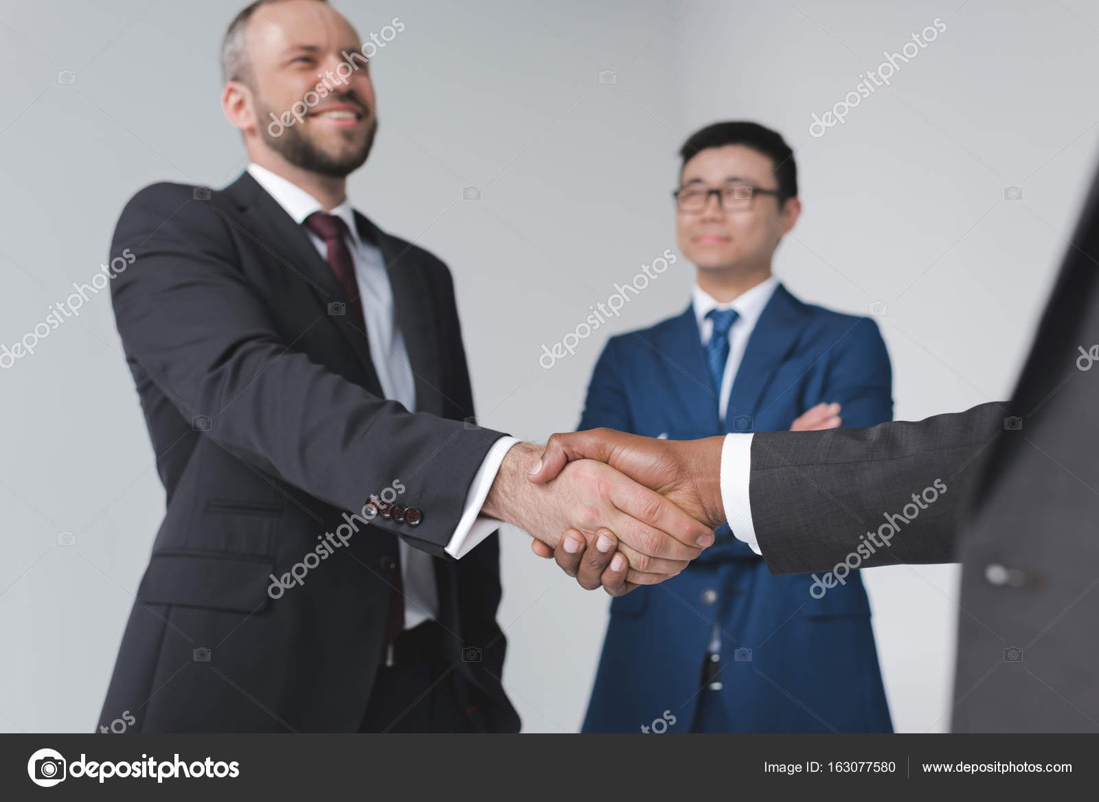 Multicultural businessmen handshake — Stock Photo © TarasMalyarevich ...