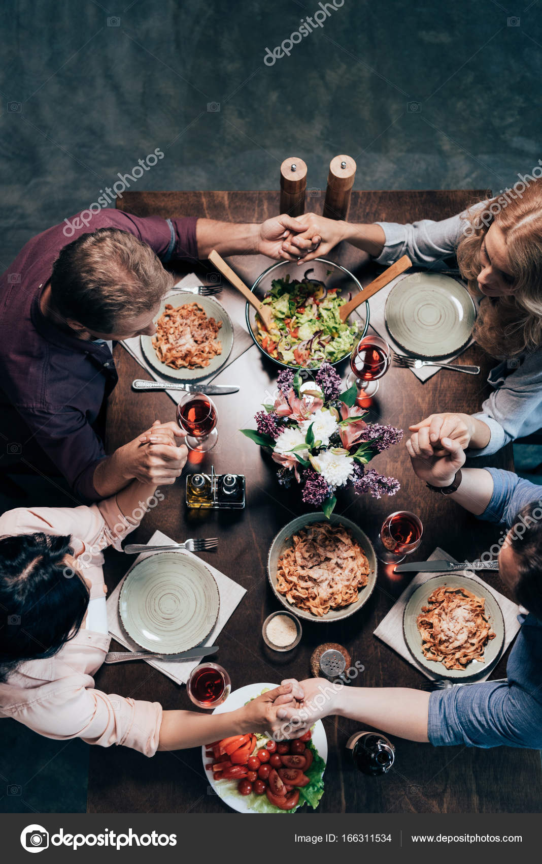 Friends praying before dinner — Stock Photo © TarasMalyarevich #166311534