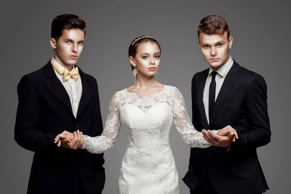 Two handsome men and beautiful bride, studio Stock Photo by ©stahov ...