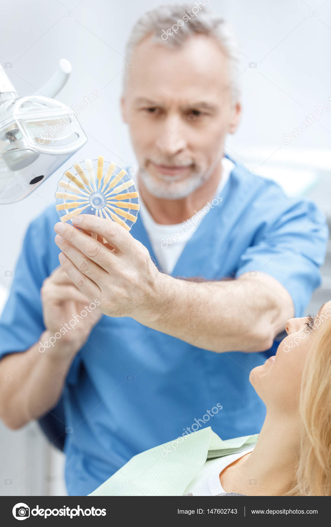 Dentist matching teeth colour — Stock Photo © AndreyBezuglov #147602743