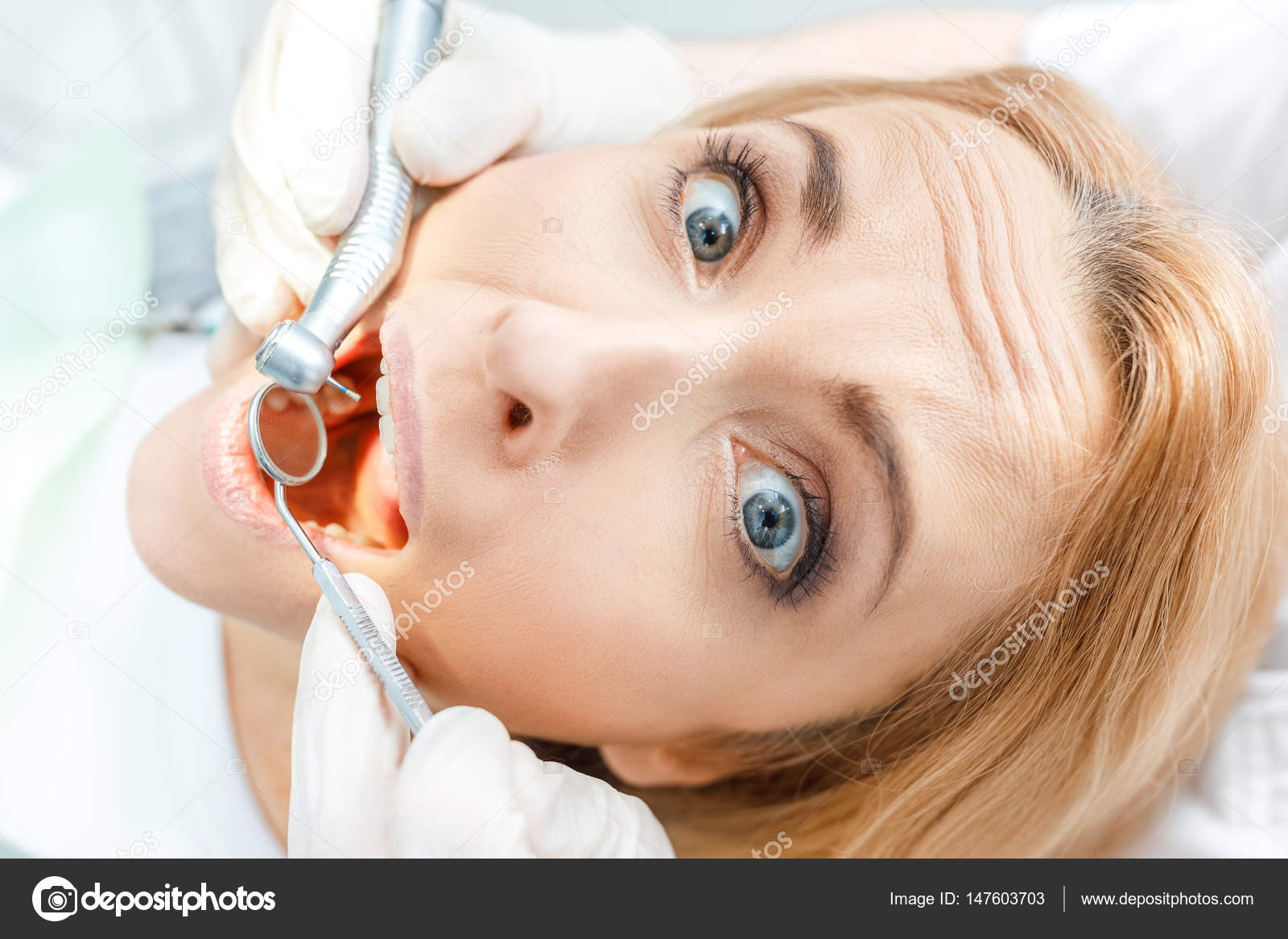 Dentist curing scared patient — Stock Photo © AndreyBezuglov #147603703