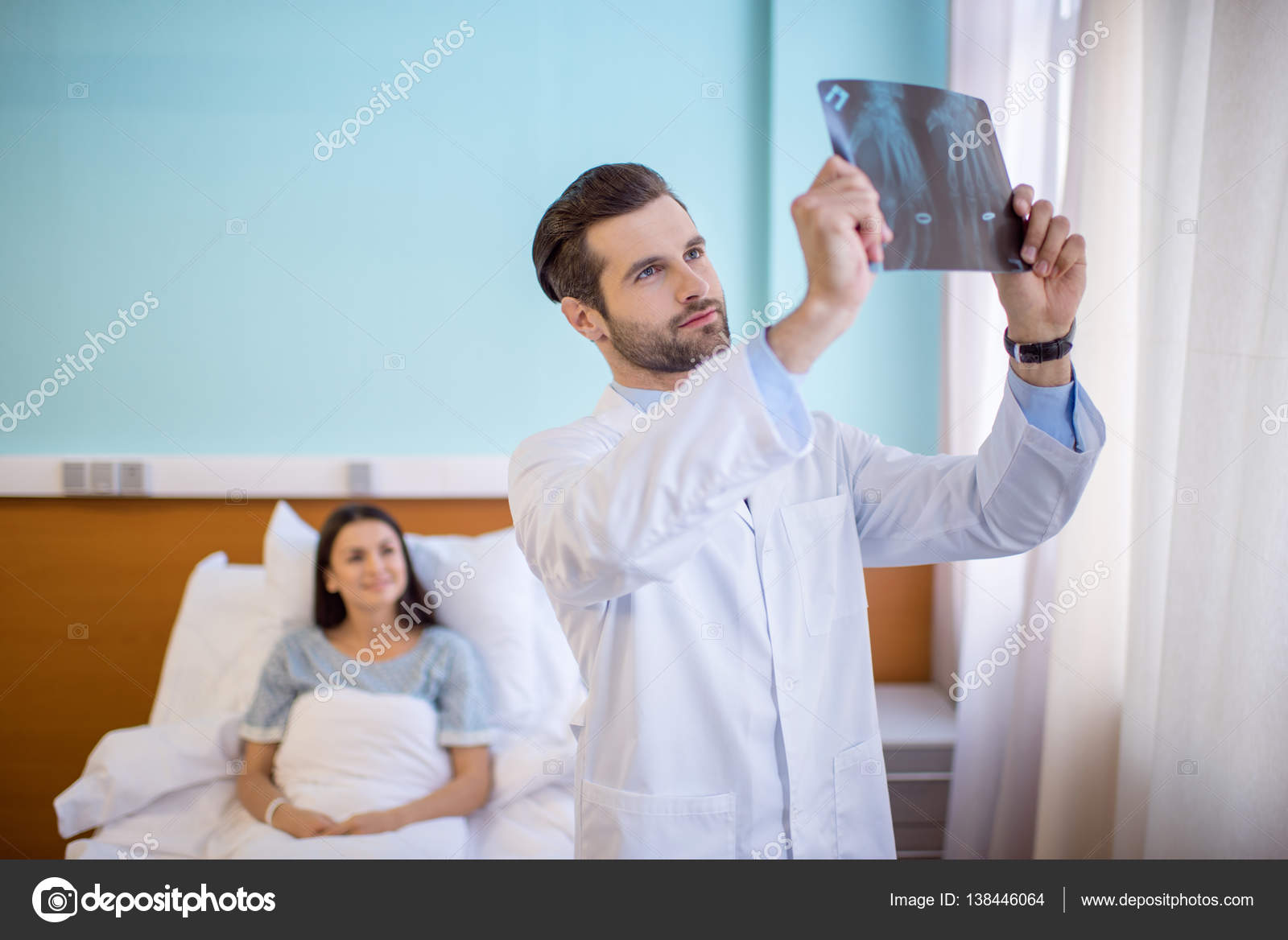 Doctor holding x-ray image Stock Photo by ©IgorTishenko 138446064