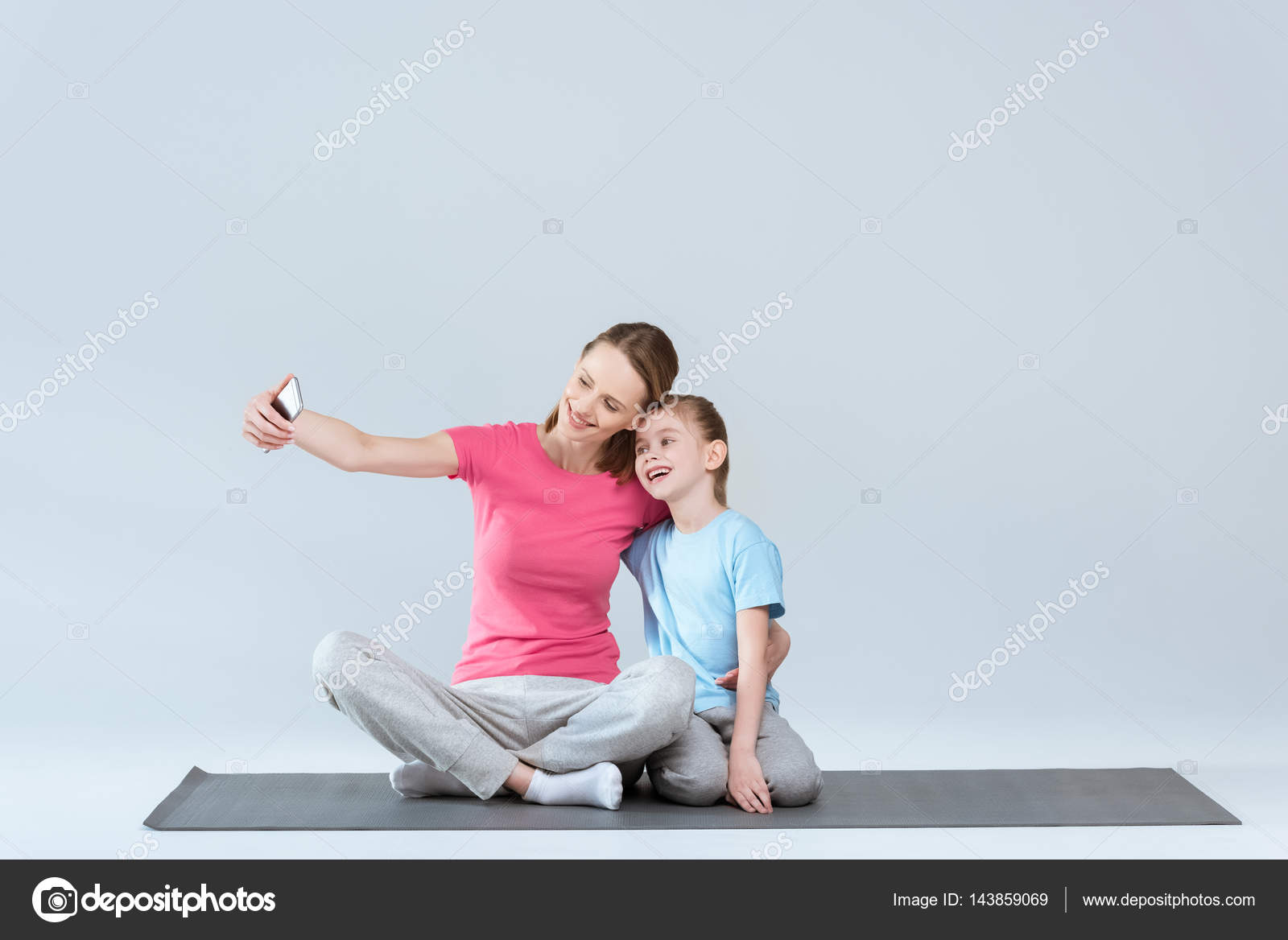 Mother and daughter taking selfie — Stock Photo © IgorTishenko #143859069 Mother and daughter taking selfie — Stock Photo © IgorTishenko #143859069