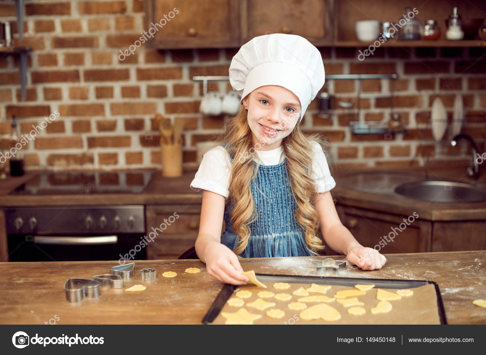 Girl making shaped cookies — Stock Photo © IgorTishenko #149450148