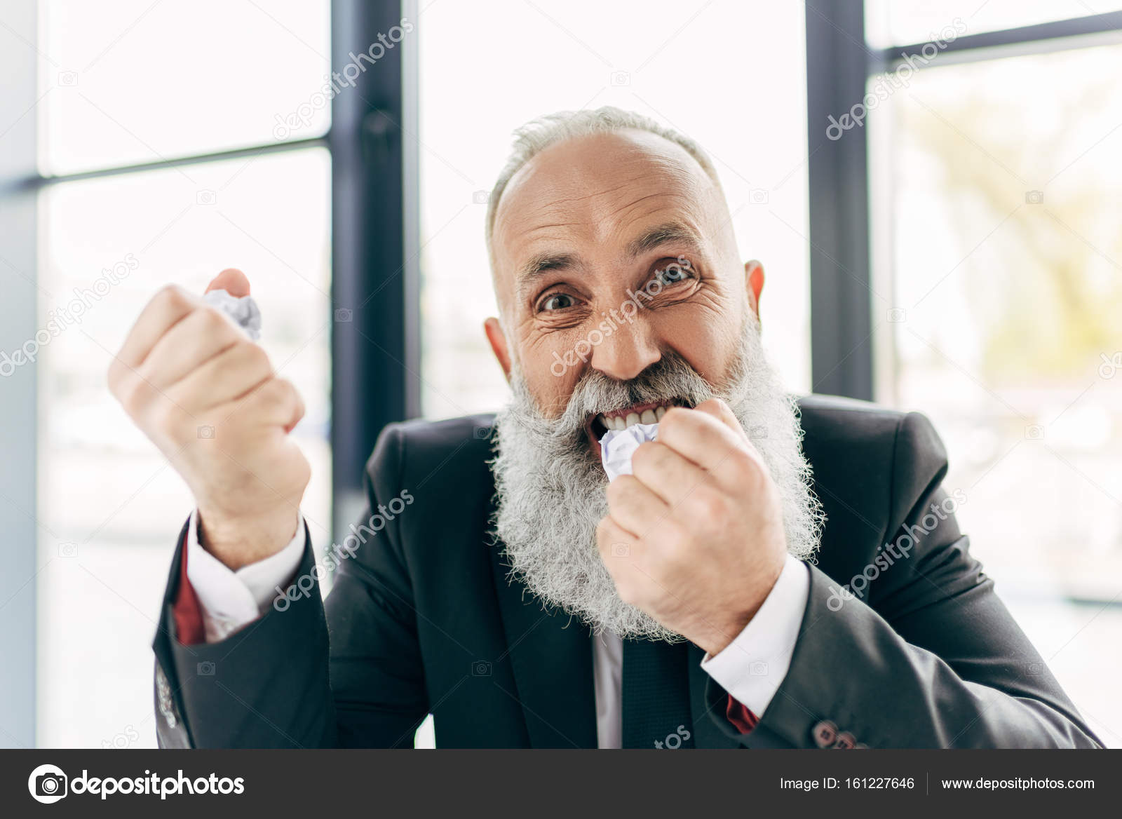 Angry businessman eating documents — Stock Photo © IgorTishenko #161227646
