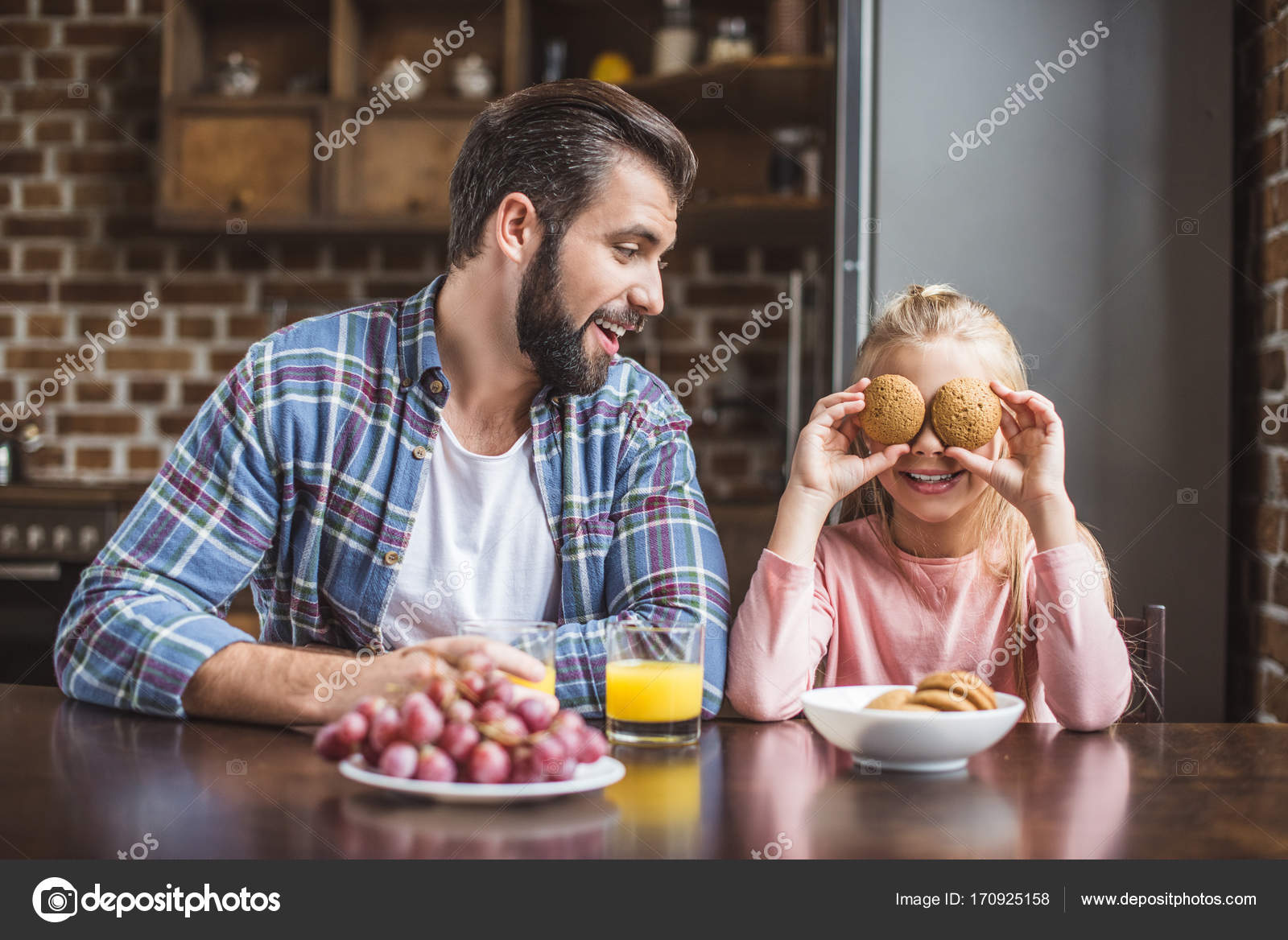 Father and daughter having breakfast — Stock Photo © IgorTishenko ...