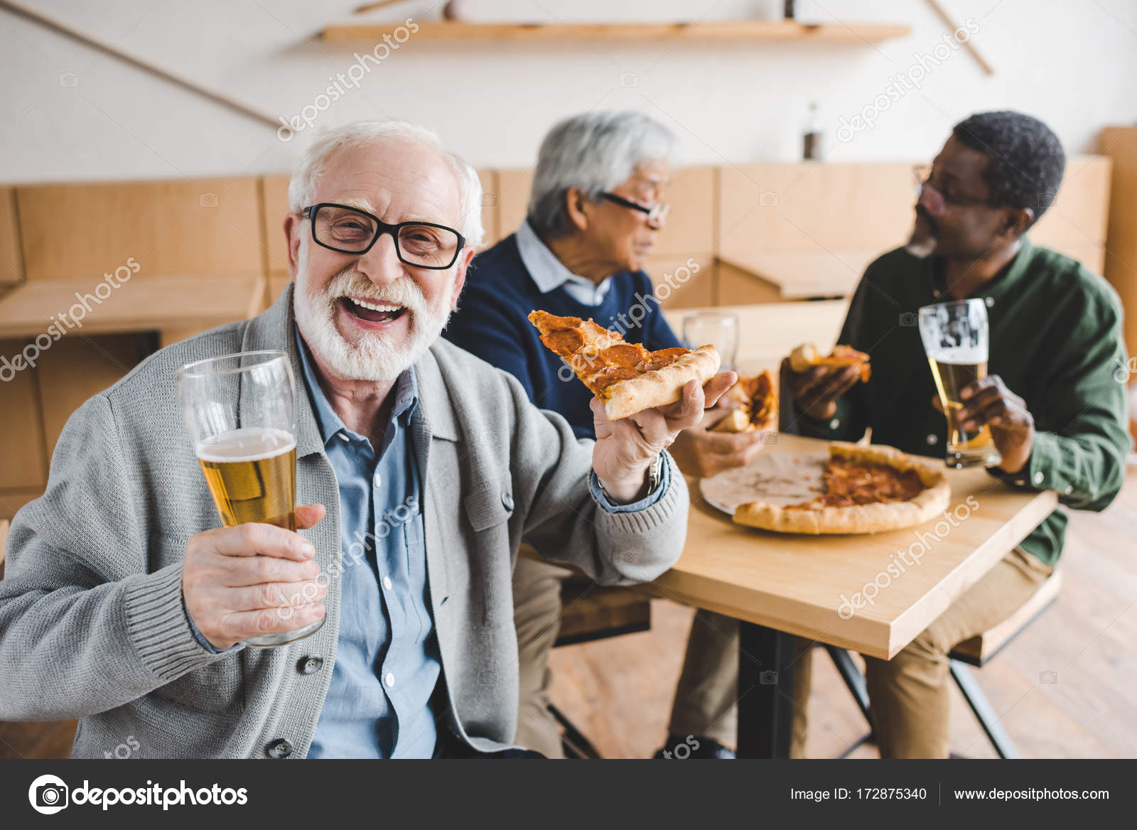Senior man eating pizza with beer Stock Photo by ©IgorTishenko 172875340