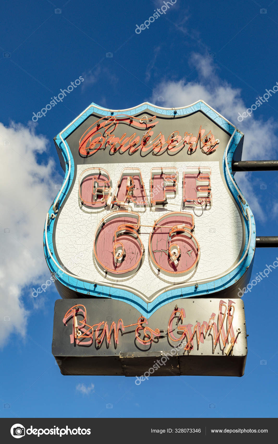Route 66 cafe neon sign for a bar and grill under clear blue sky ...
