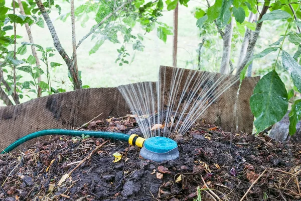Humidification compost pile using sprinkler — Stock Photo © Photozirka ...
