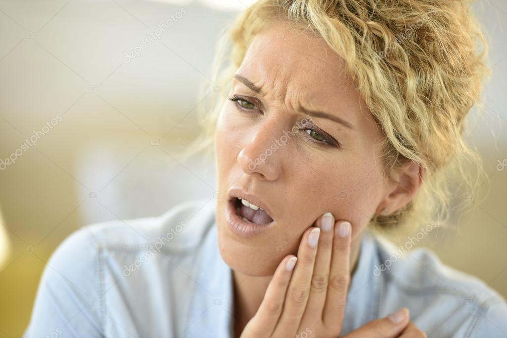 Woman suffering toothache Stock Photo by ©Goodluz 128046270