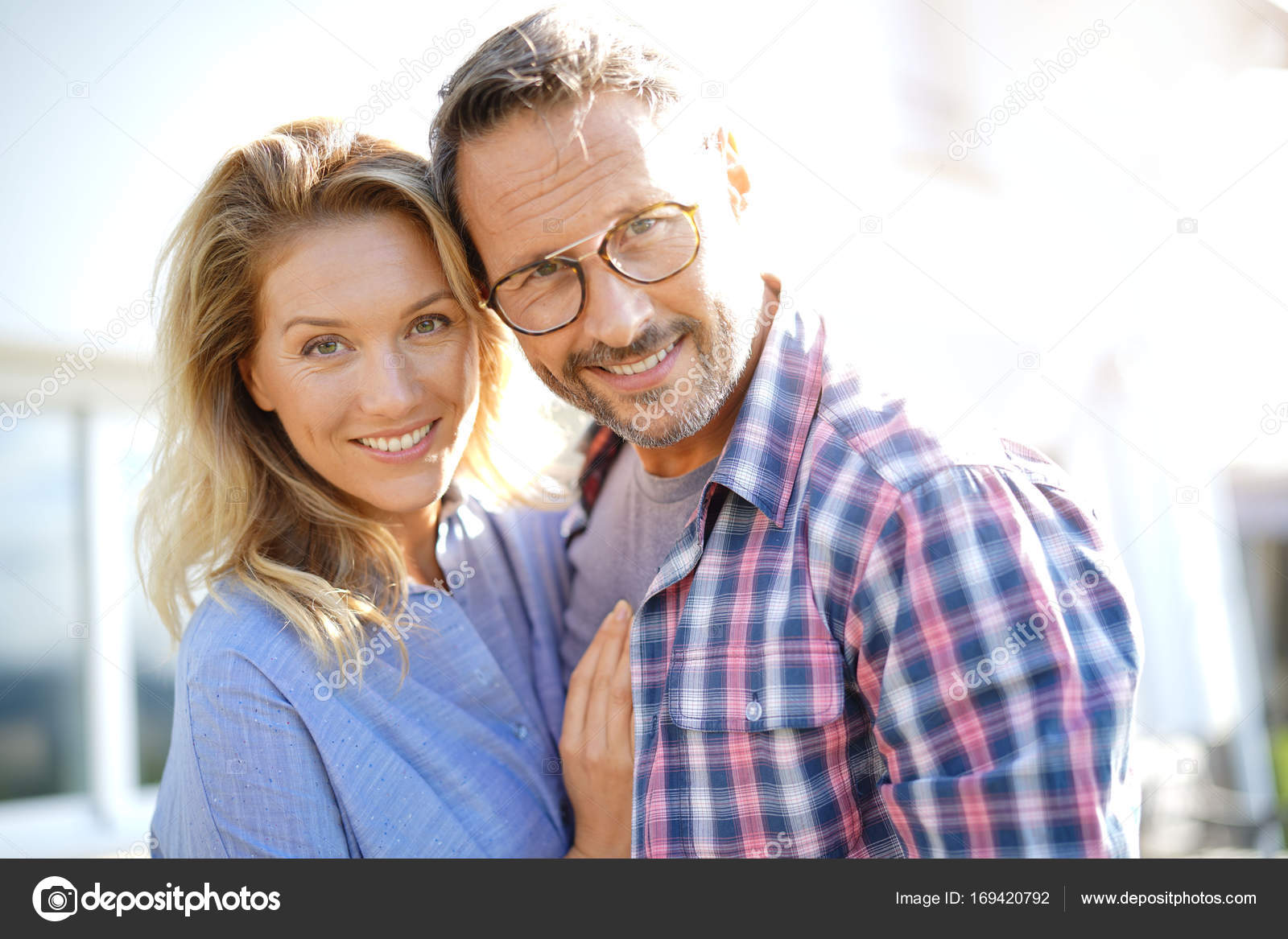 Couple relaxing on outdoor sofa — Stock Photo © Goodluz #169420792