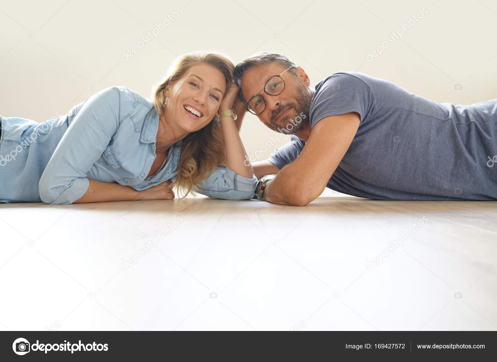 Mature Couple Laying Floor Looking Camera — Stock Photo © Goodluz ...