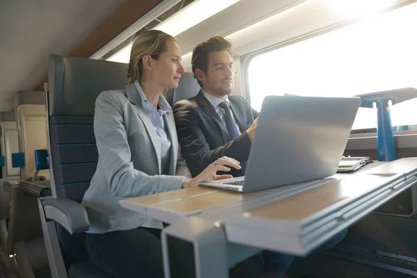 two colleagues working on a train - Stock Image - Everypixel