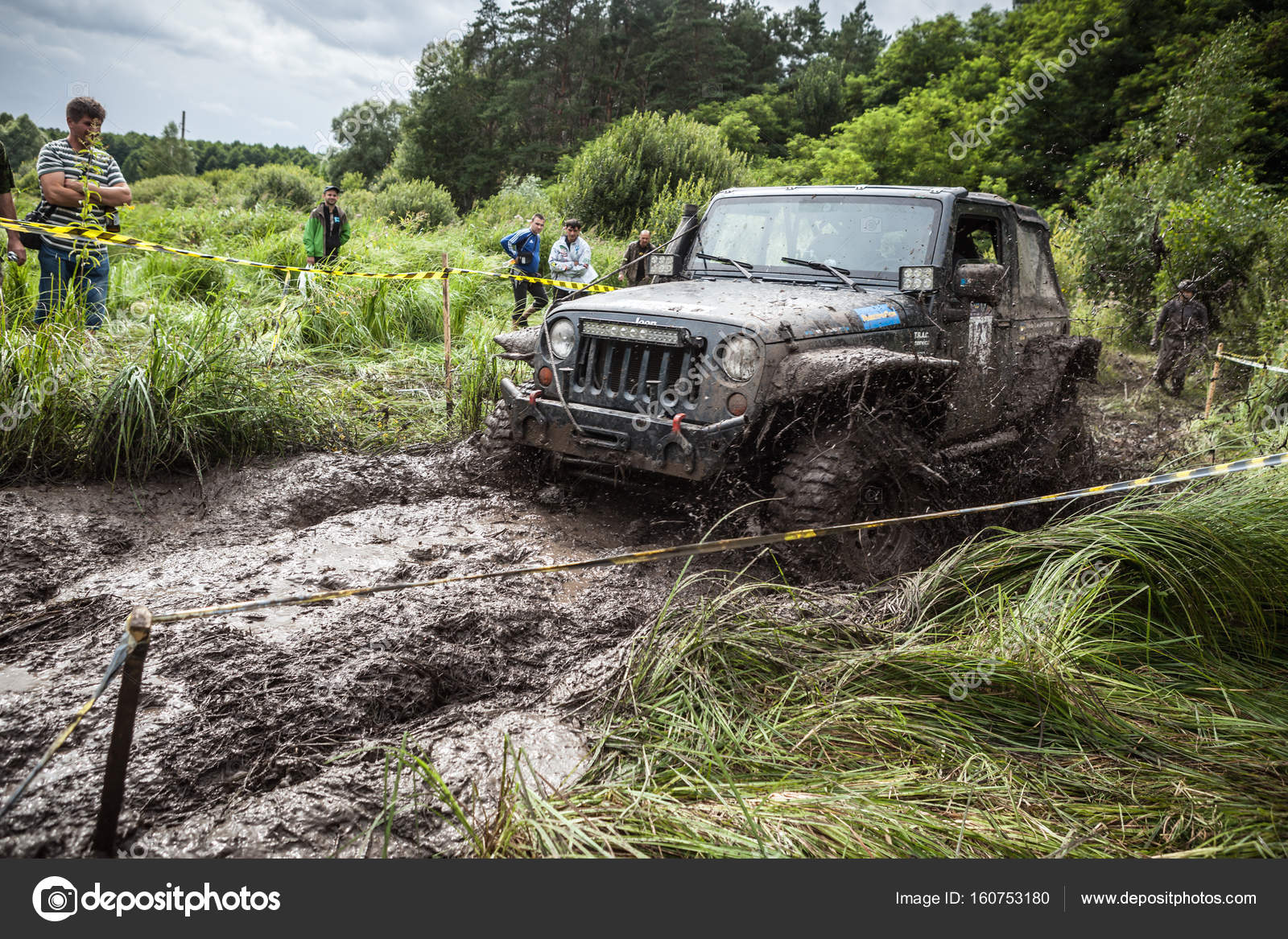 The participant on Jeep passes a deep muddy pit. – Stock Editorial ...