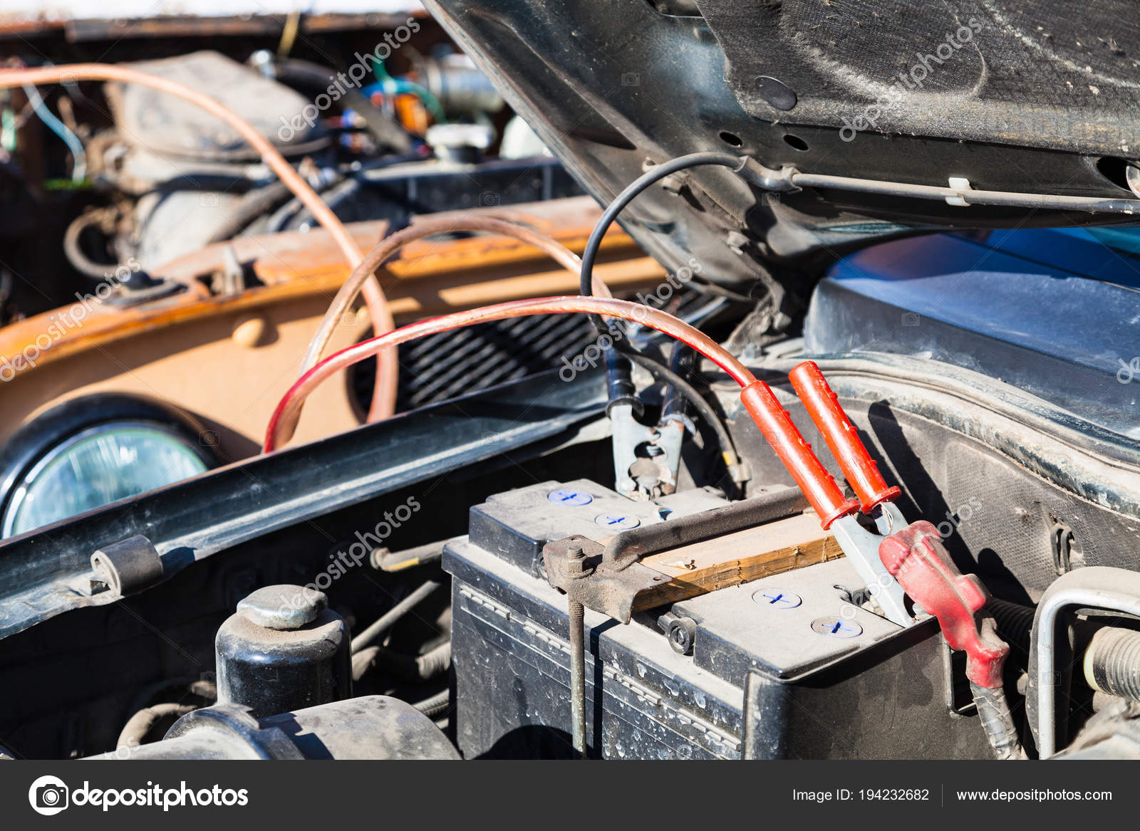 Jump starting old car battery with another vehicle Stock Photo by ...