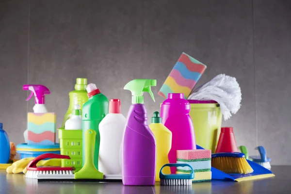 Colorful set of home cleaning products on the gray tiles. Place for ...