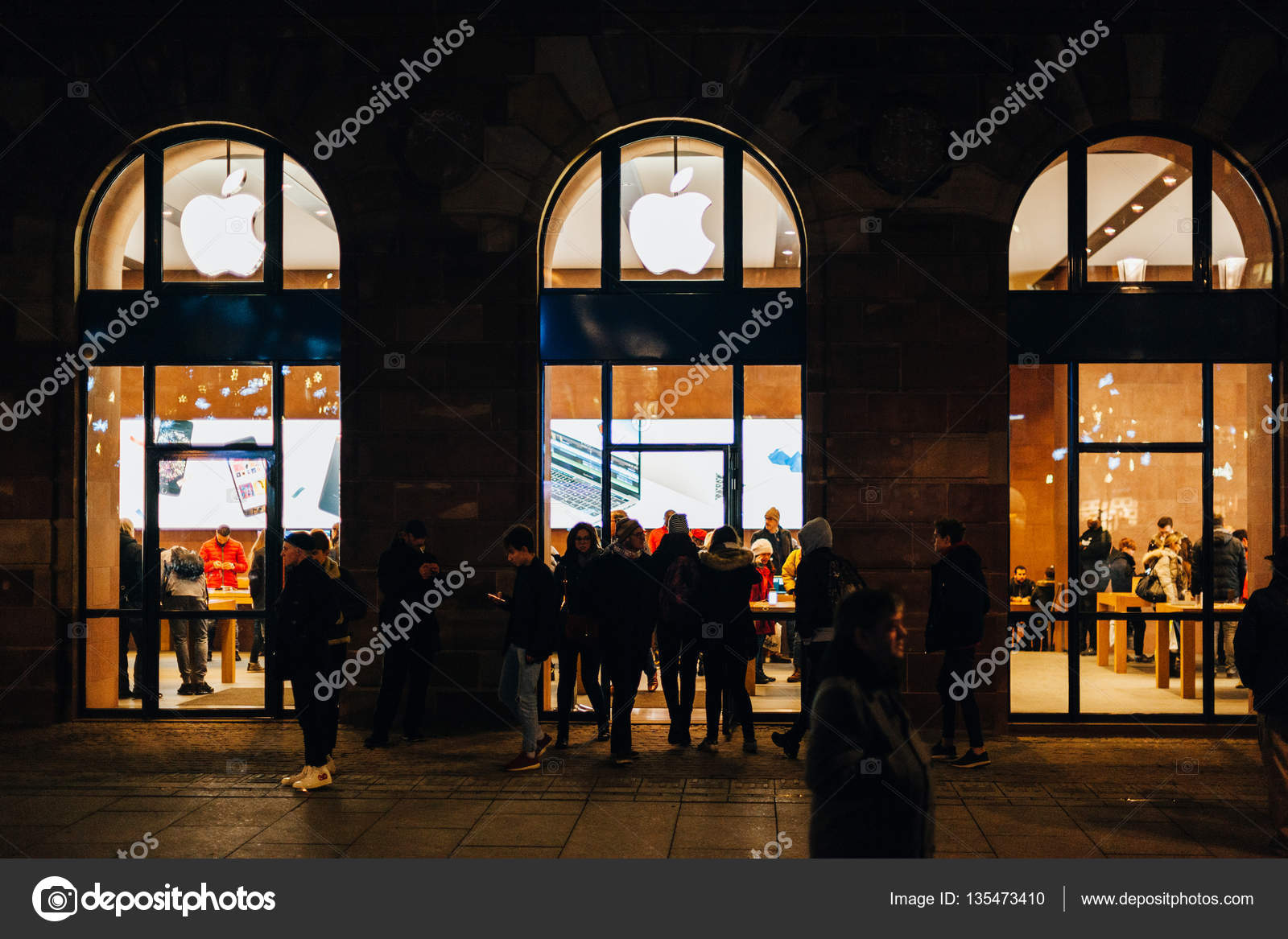 People in front of Apple Store facade at night – Stock Editorial Photo ...