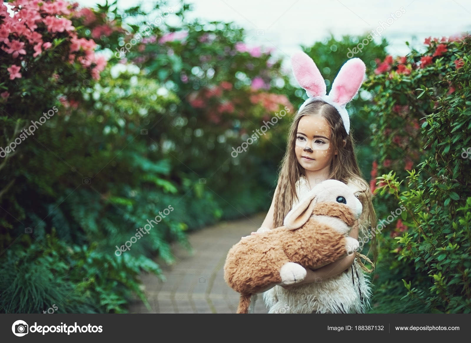 Children play with toy rabbit. Laughing child at Easter egg hunt with ...