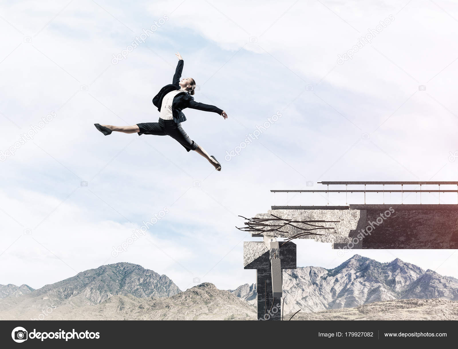 Woman jumping over huge gap Stock Photo by ©Khakimullin 179927082